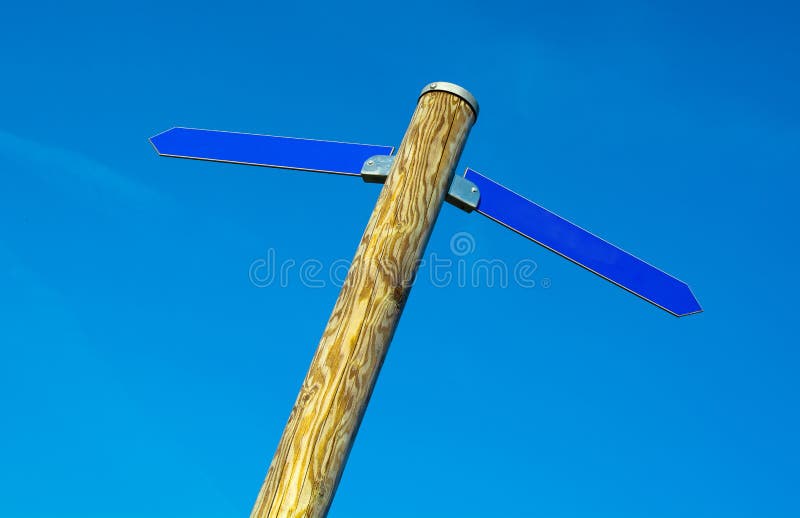 Wooden Pole with Blue Direction Arrows Stock Image - Image of direction ...