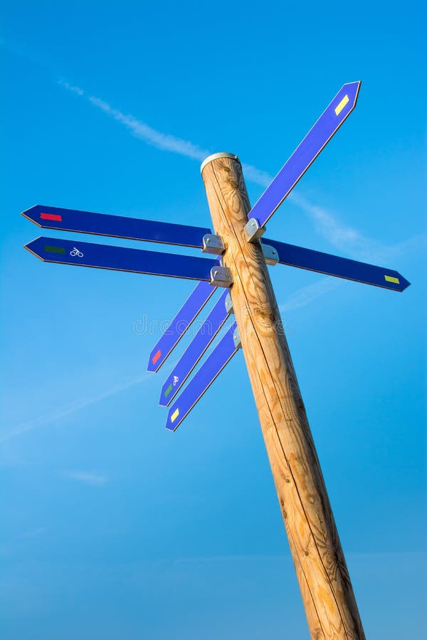Wooden Pole with Blue Direction Arrows Stock Image - Image of direction ...