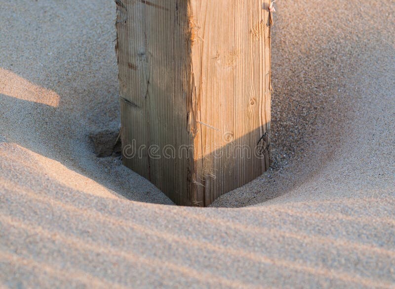 Wooden Post Buried in the Sand Stock Image - Image of buried, sunlight ...