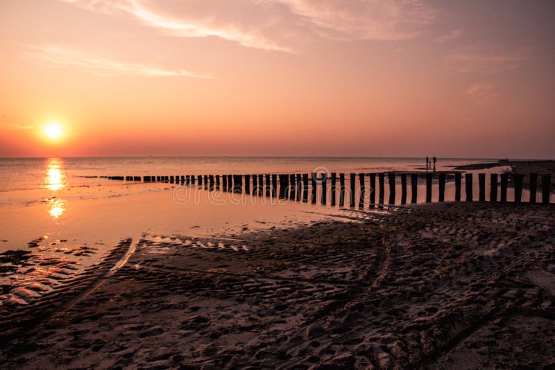 Wooden Posts at the Beach Pictured at Sunset Stock Photo - Image of ...