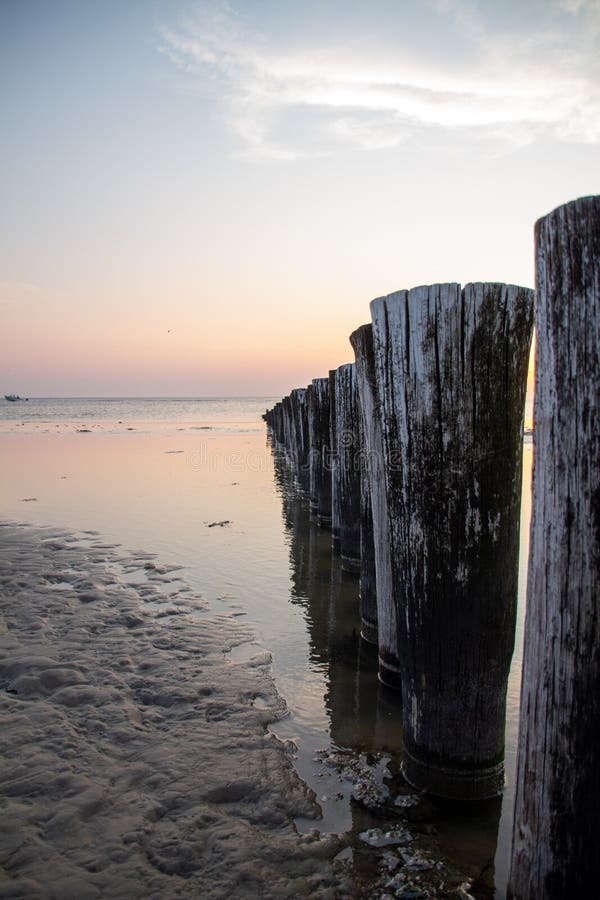 Wooden Posts at the Beach Pictured at Sunset Stock Photo - Image of ...