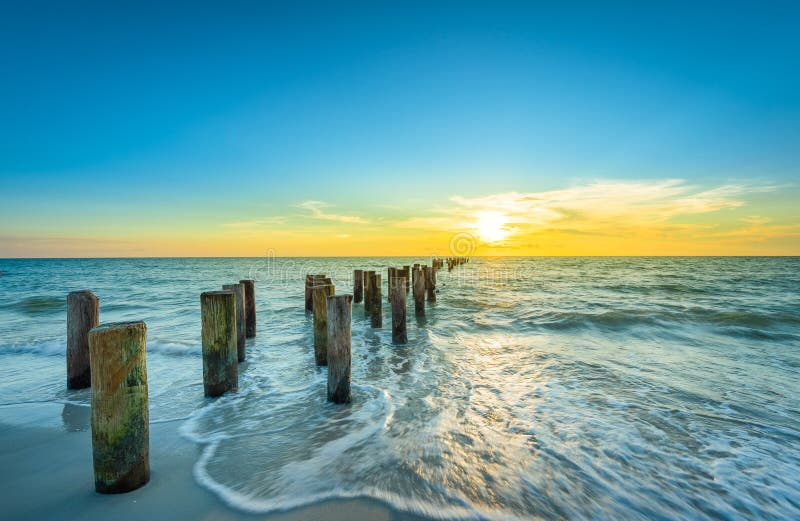 Wooden Posts on Naples Beach at Sunset, Florida Stock Image - Image of ...