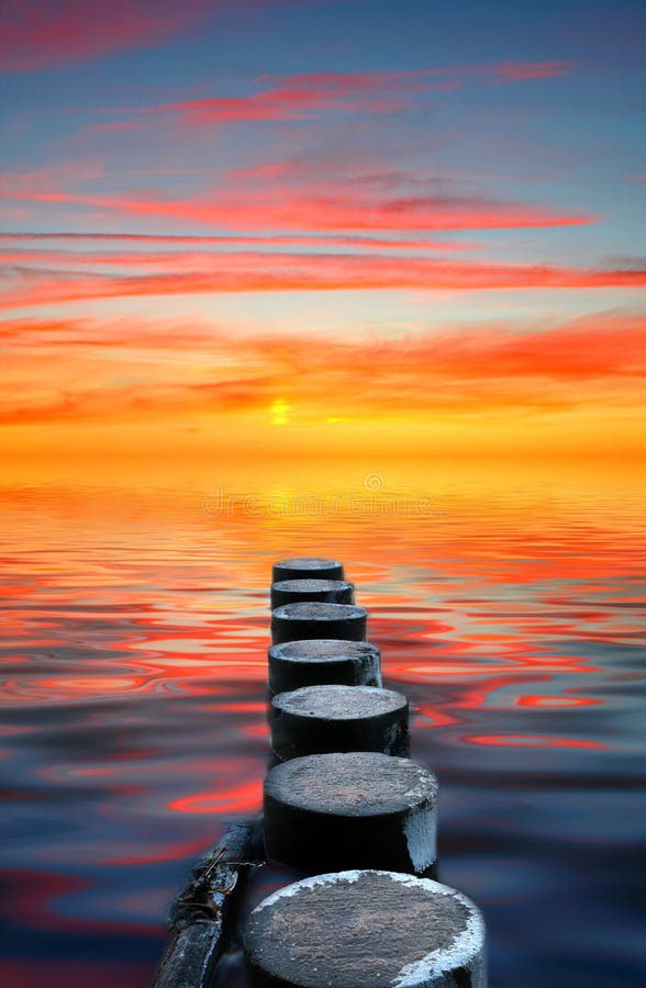 Wooden Posts and Ocean Sunset Stock Image - Image of glowing, covered ...