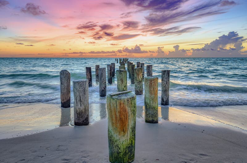 Wooden Posts on the Sandy Beach at Sunset. Naples Beach, Florida Stock ...