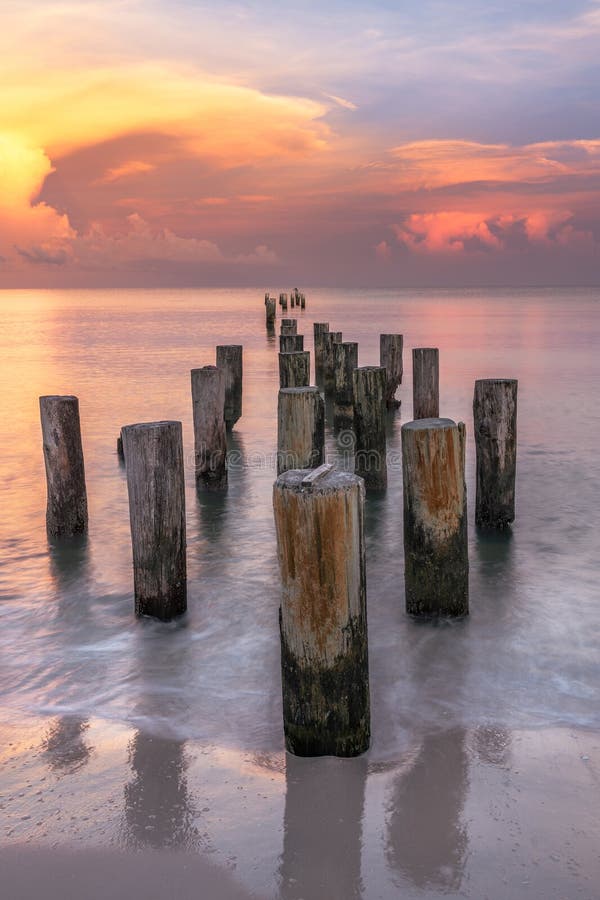 Wooden Posts on the Sandy Beach at Sunset. Naples Beach, Florida Stock ...