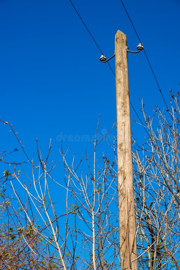 Wooden Power Pole with Two Lines in Front of Blue Sky Stock Photo ...