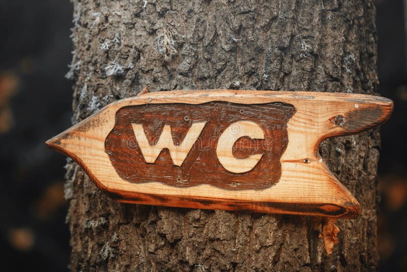 Wooden Public Toilet Sign Pointer Attached To a Tree. WC Direction ...