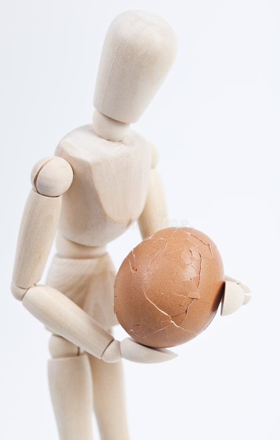 Wooden Puppet with a Broken Egg Stock Image - Image of fragile, holding ...
