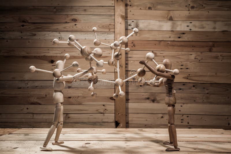 Wooden Puppets with Atom Word Stock Image - Image of atom, wood: 124042343