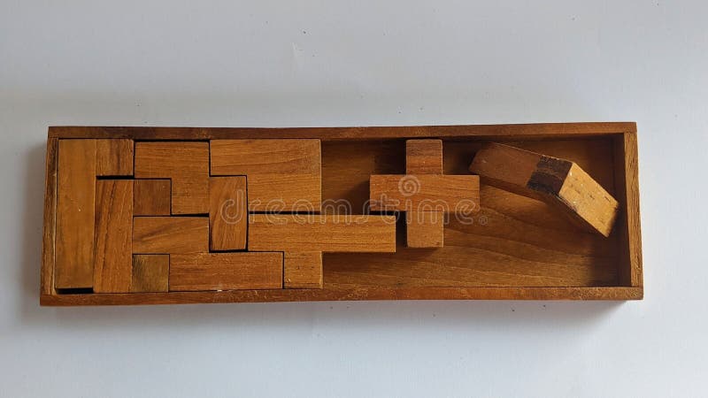 A Wooden Puzzle Box with Various Wooden Pieces Inside. the Box Has a ...