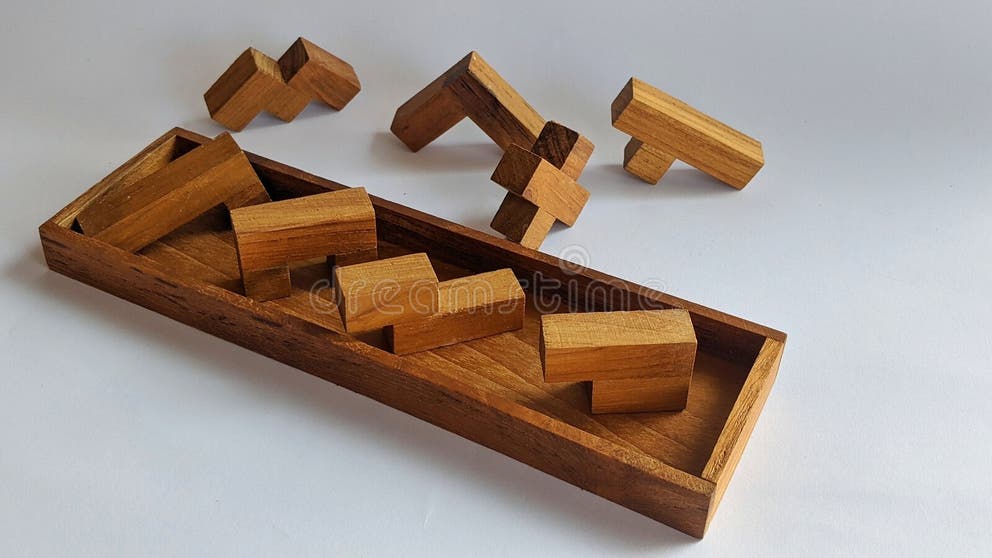 A Wooden Puzzle Box with Various Wooden Pieces Inside. the Box Has a ...