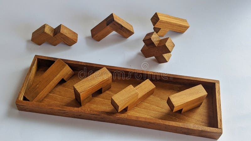 A Wooden Puzzle Box with Various Wooden Pieces Inside. the Box Has a ...