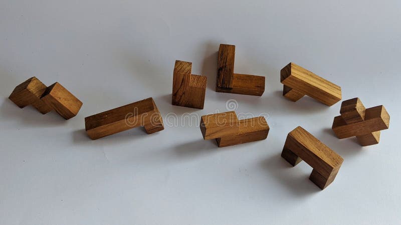 A Wooden Puzzle Box with Various Wooden Pieces Inside. the Box Has a ...