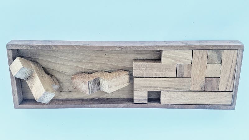 A Wooden Puzzle Box with Various Wooden Pieces Inside. the Box Has a ...
