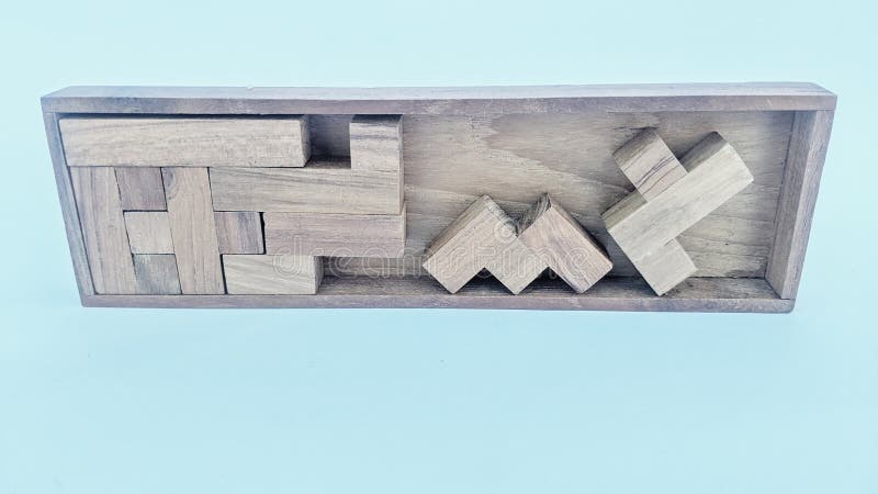 A Wooden Puzzle Box with Various Wooden Pieces Inside. the Box Has a ...