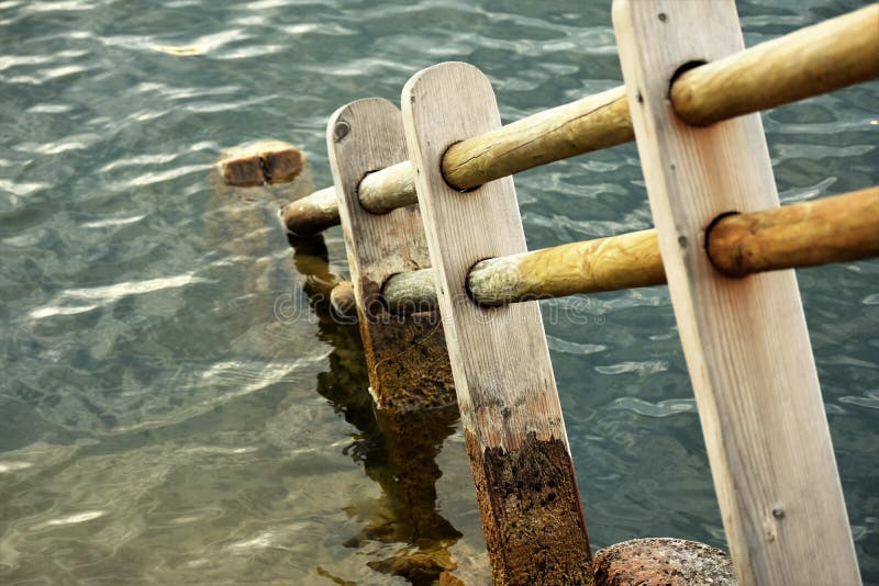 Wooden Rail Leading into Water Stock Photo - Image of nature, outdoors ...