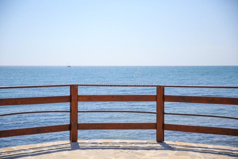 Wooden railing on the pier stock photo. Image of view - 153647070