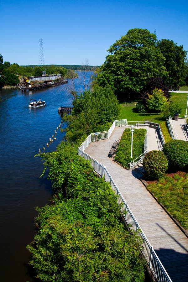 Wooden Ramp Going Down between Trees Follows the Blue River on a Clear ...