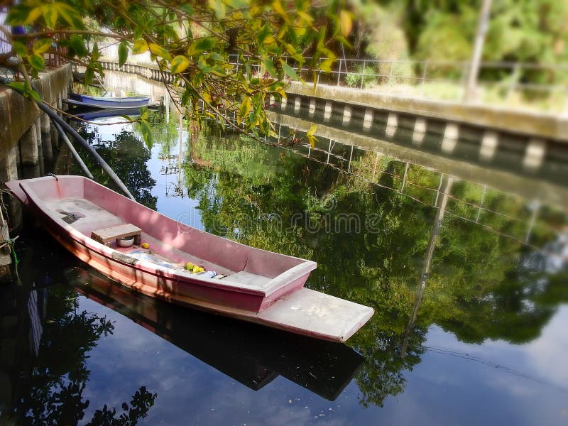 Wooden Red Boat in Small Csbsl with Reflection of Tree in Clear Water ...