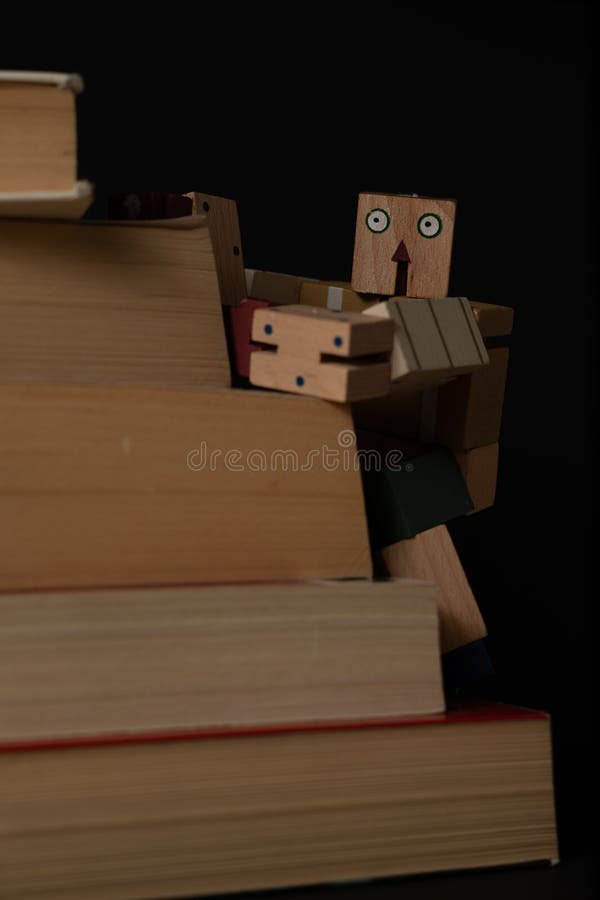 Wooden Robot Climbing Stack of Books for Personal Growth Stock Image ...