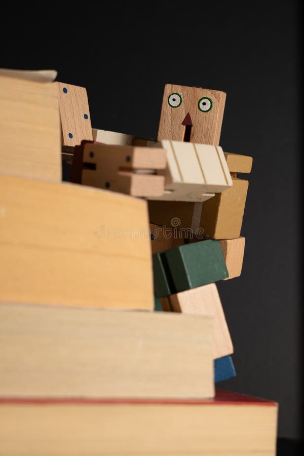 Wooden Robot Climbing Stack of Books for Personal Growth Stock Image ...