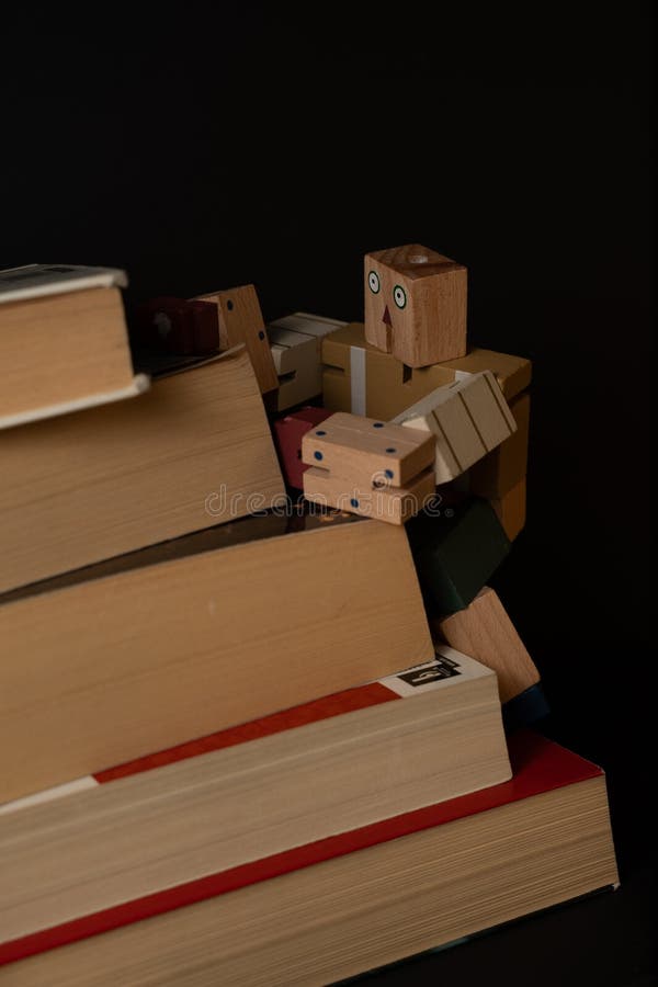 Wooden Robot Climbing Stack of Books for Personal Growth Stock Image ...