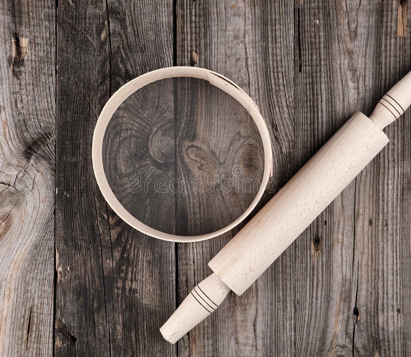 Wooden Rolling Pin and a Wooden Round Sieve on a Gray Table Stock Photo ...