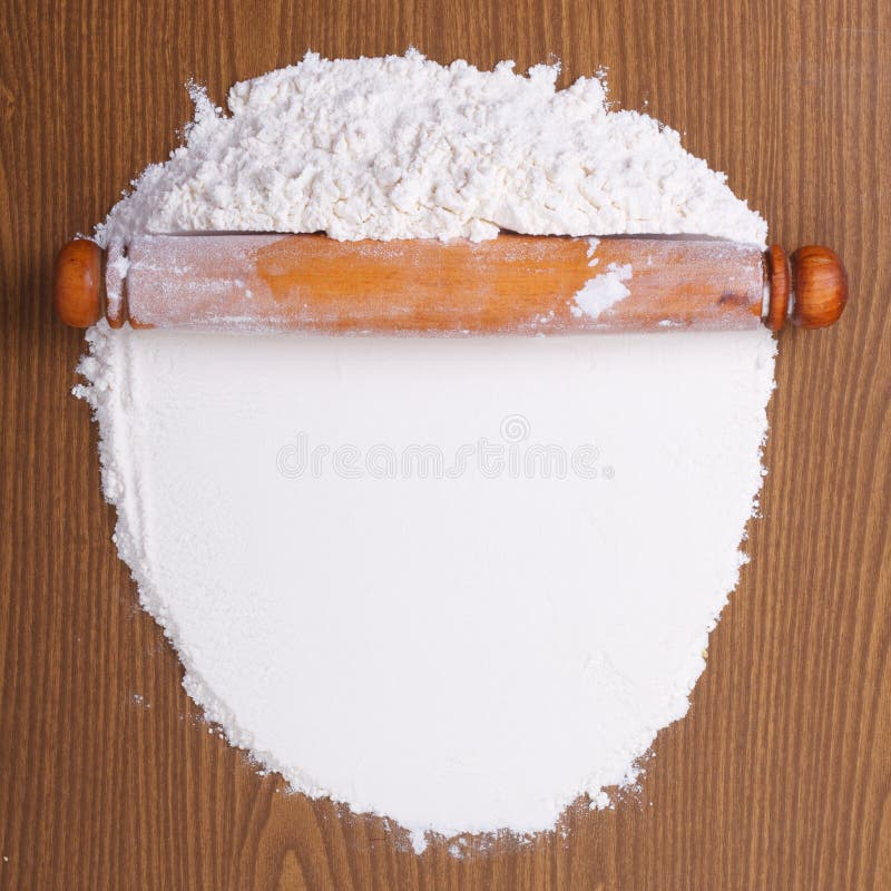 Wooden Rolling Pin with White Wheat Flour on the Table Stock Image ...