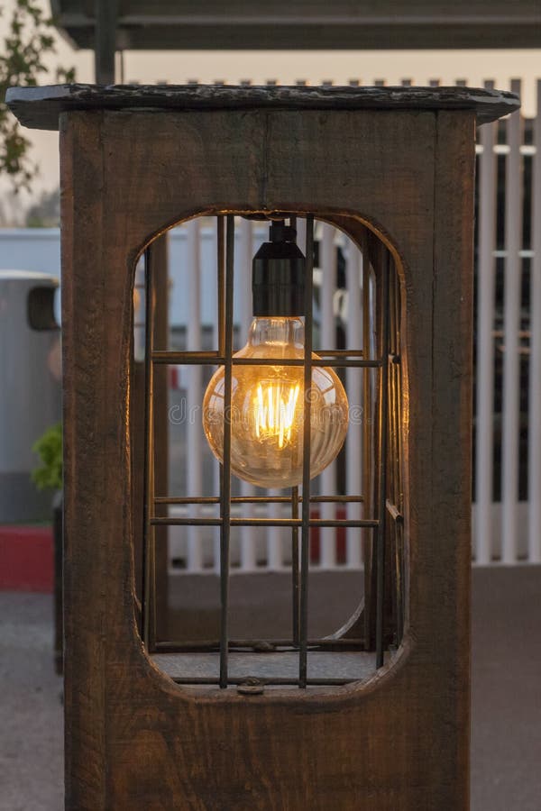 Wooden Rustic Lantern with Led Bulb Glowing at Dusk Stock Photo - Image ...