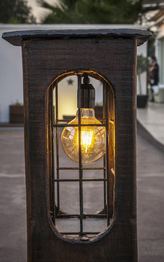 Wooden Rustic Lantern with Led Bulb Glowing at Dusk Stock Image - Image ...