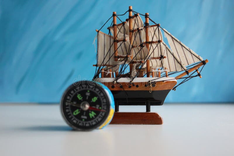 Wooden Sailing Ship Model and Vintage Compass on White Surface Over ...
