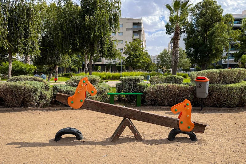Wooden seesaw in the park stock photo. Image of outdoors - 262755190