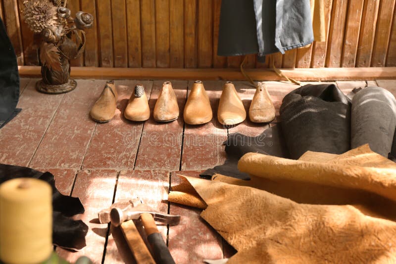 Wooden Shoe-trees with Craft Tools and Leather on Floor in Workshop ...