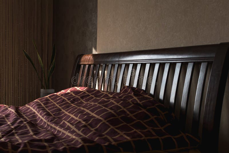 Wooden Sleeping Bed in a Dark Room Stock Photo - Image of pillow ...