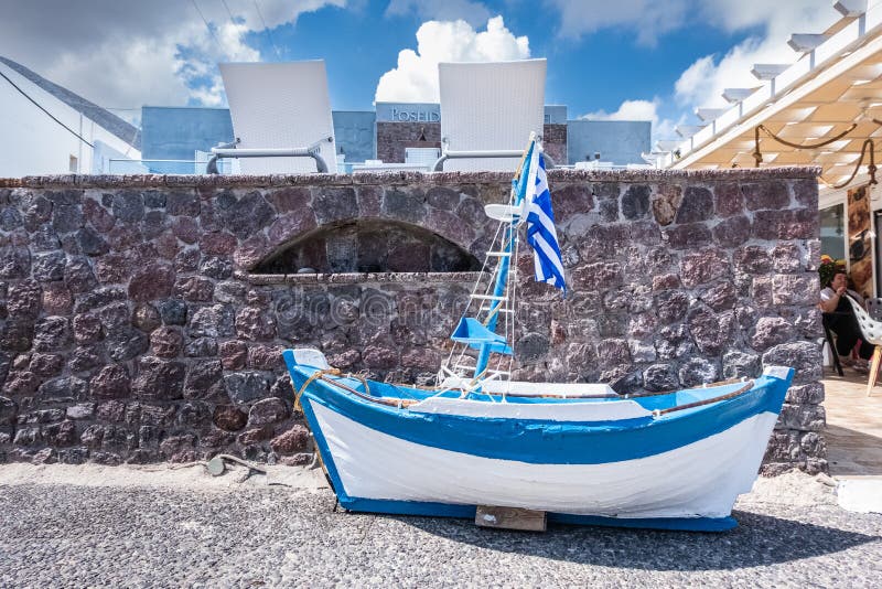 Wooden Small Blue and White Boat in Front of a Wall of Santorini. Stock ...