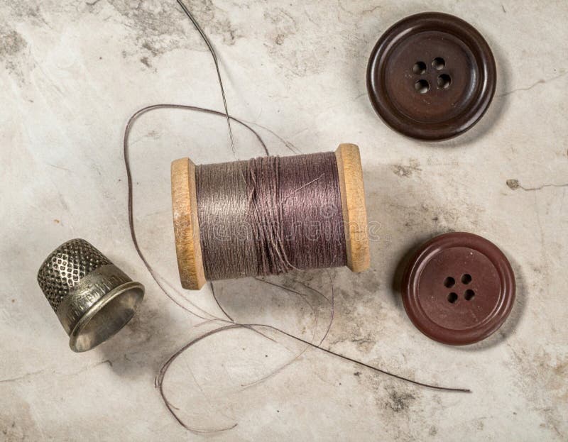 Wooden Spool of Brown Thread with Buttons and Thimble Stock ...