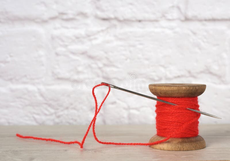 Wooden Spool with Red Wool Thread on Shelf, White Wall Stock Photo ...