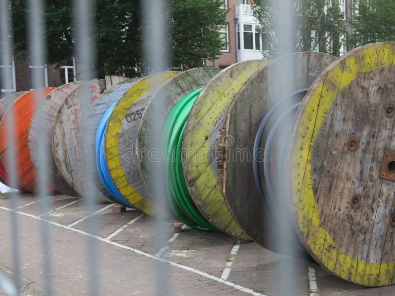 Wooden Spools with Cables in Different Colors Laying on the Sidewalk ...