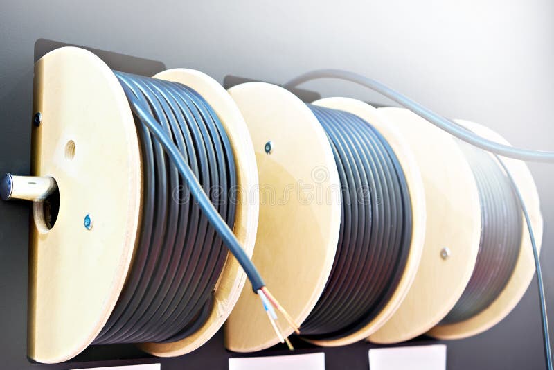 Wooden spools with cables stock image. Image of distribution - 209283919