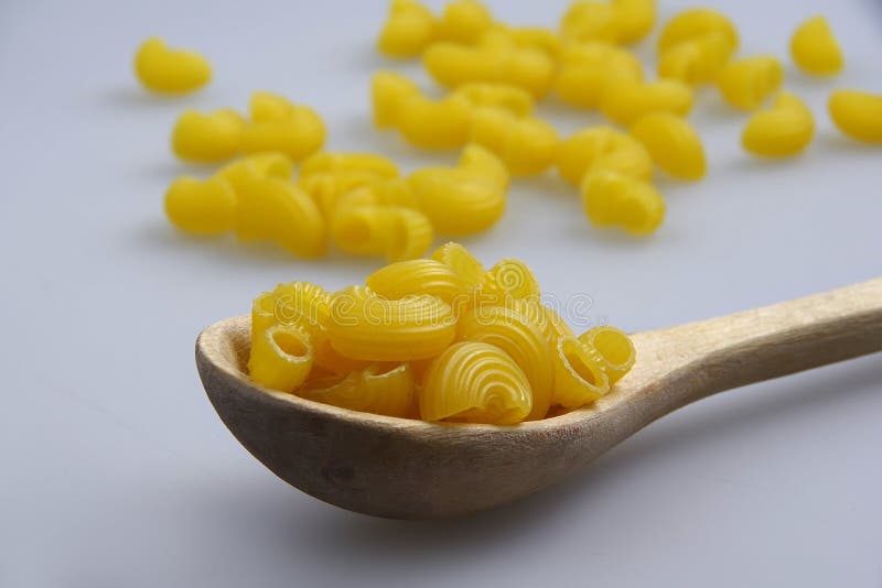 Wooden Spoon Full of Macaroni with Some on the Background Stock Image ...