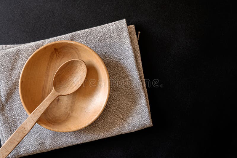 Wooden Spoon and Plate on a Napkin Stand on a Black Table Stock Image ...