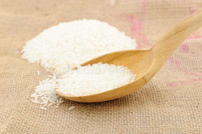 Wooden spoon with raw rice stock image. Image of brown - 27599351