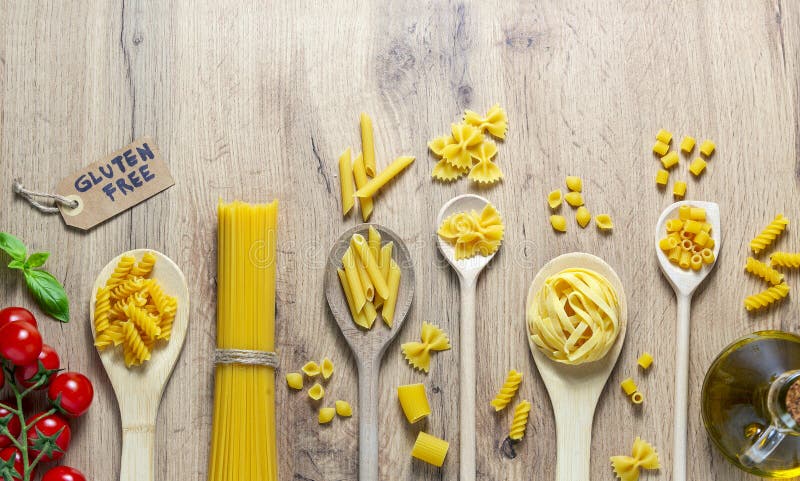 Wooden Spoons with Different Types of Pasta, Tomato, Oil and Gluten ... Wooden Spoons with Different Types of Pasta, Tomato, Oil and Gluten ...