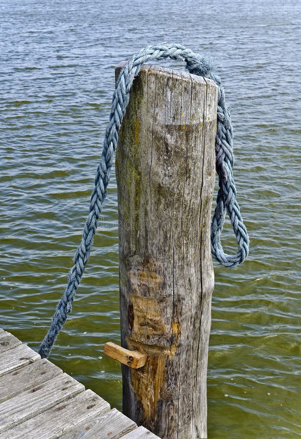 Wooden stake and blue rope stock image. Image of pier - 73700583