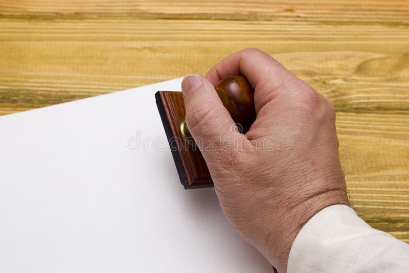 Wooden stamp in hand stock photo. Image of approved, stamp - 70923320
