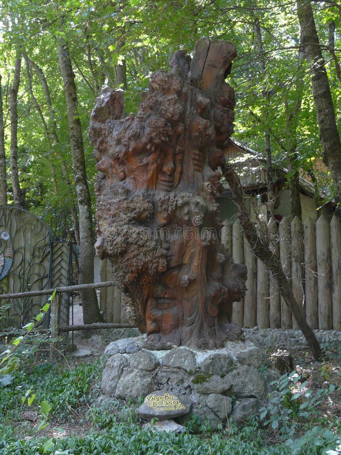 A Wooden Statue is Called a Fairy Tale Tree Featuring Various Faces at ...