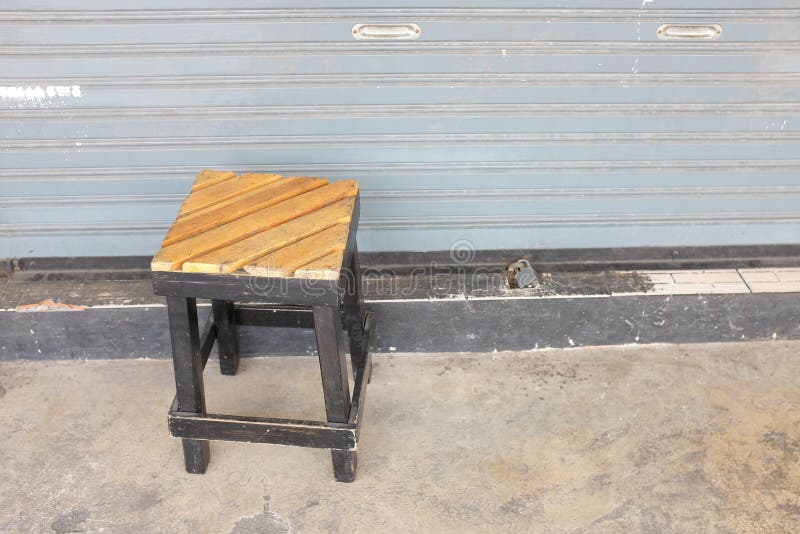 Wooden Stool in Front of Metal Door Stock Image - Image of interior ...