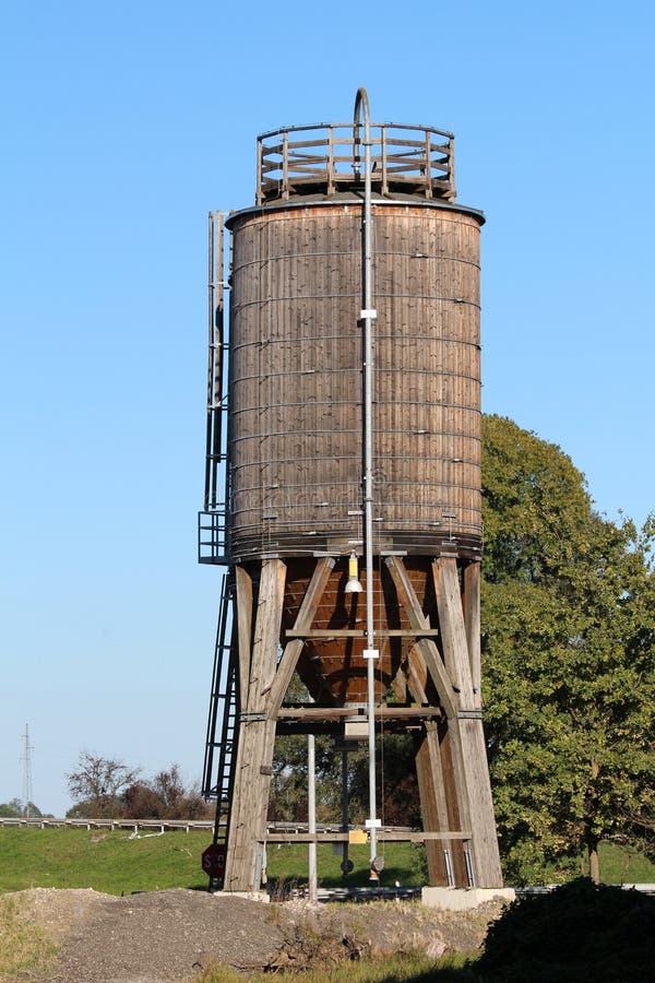 Old Wooden Storage Silo with Metal Support Frame and Narrow Metal Pipe ...