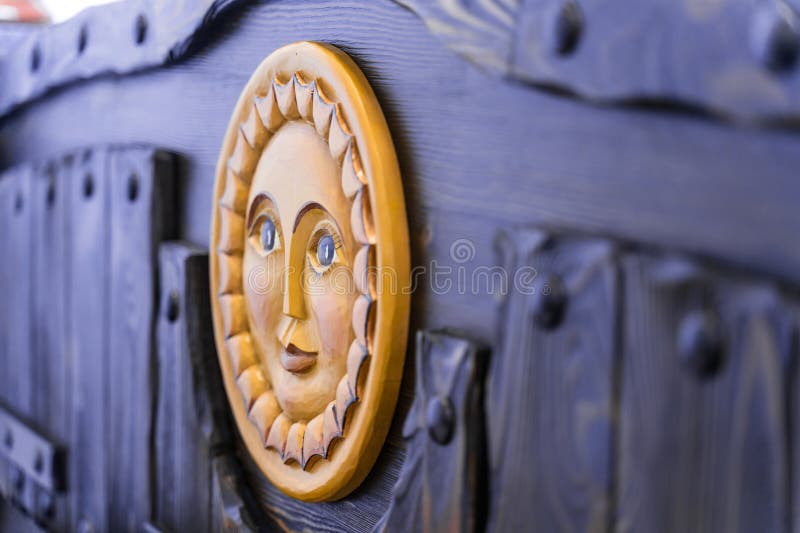 A Wooden Sun with a Face Carved into it Stock Image - Image of people ...