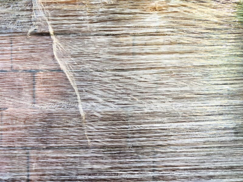 A Wooden Surface is Partially Covered with Translucent Plastic Wrap ...